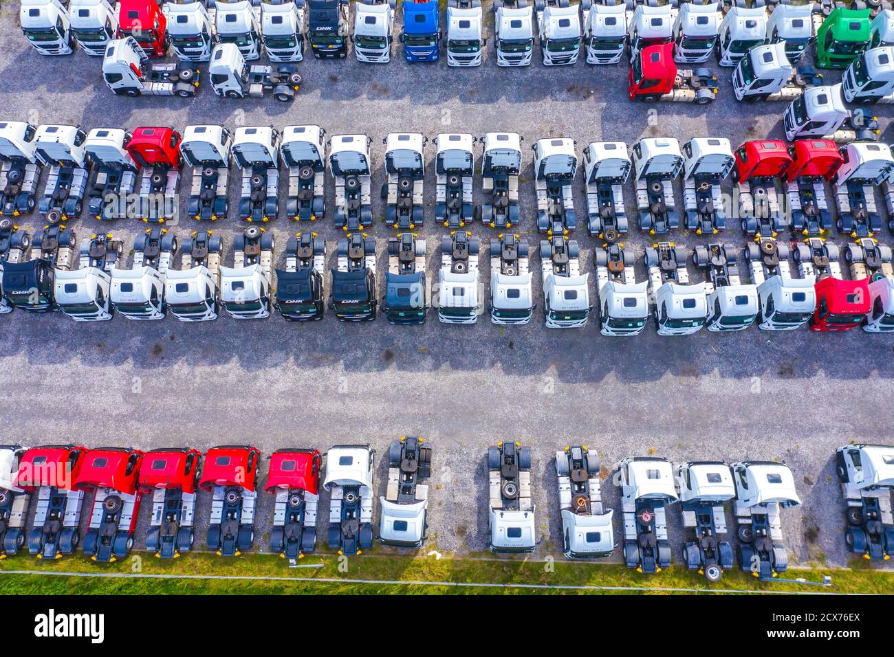 Aerial view of a car distribution centre, new cars parked in rows on a ...