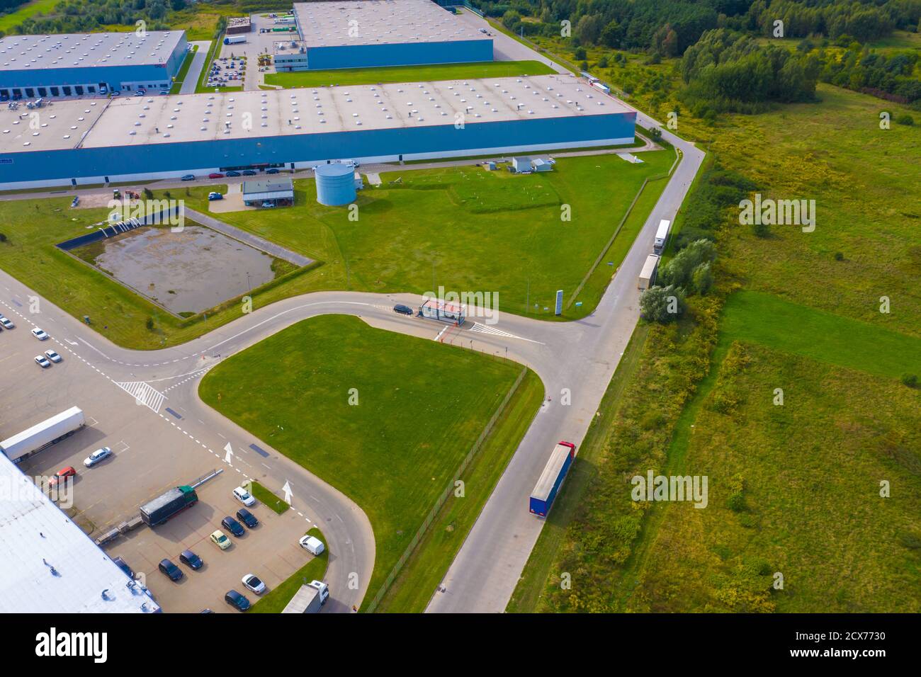 Aerial view of storage and freight terminal with trucks and containers ...