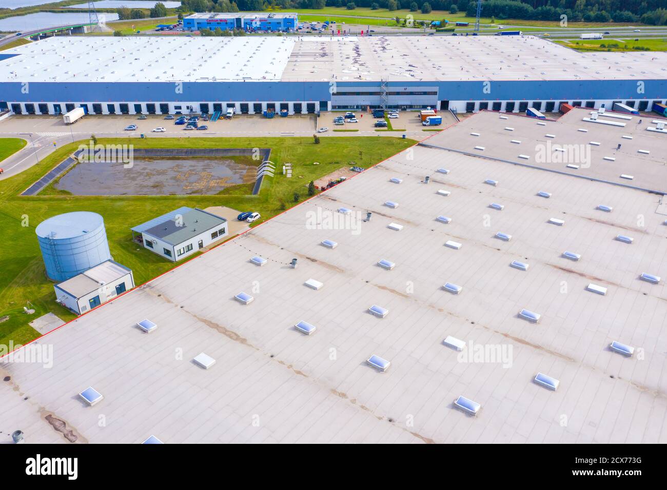 Aerial drone view of group of large modern industrial warehouse or ...