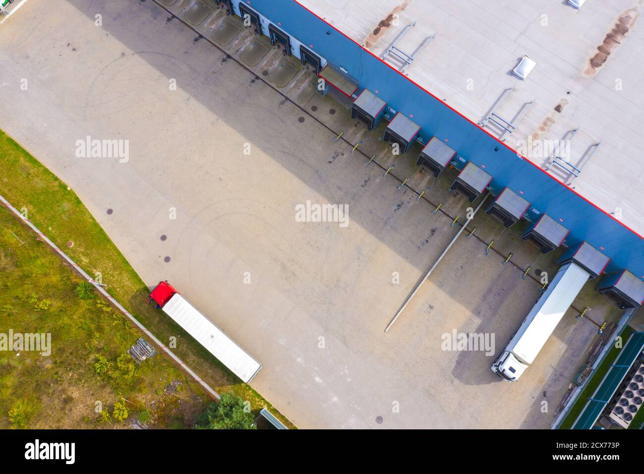 Aerial drone view of group of large modern industrial warehouse or ...