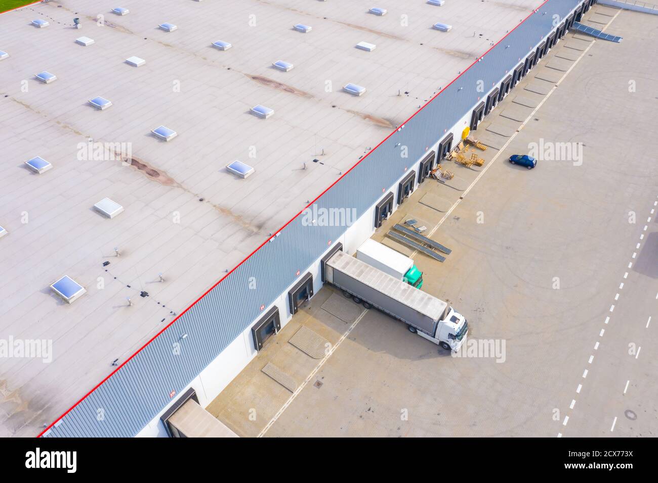 Aerial drone view of group of large modern industrial warehouse or ...