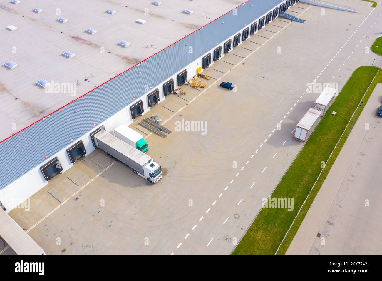 Aerial drone view of group of large modern industrial warehouse or ...
