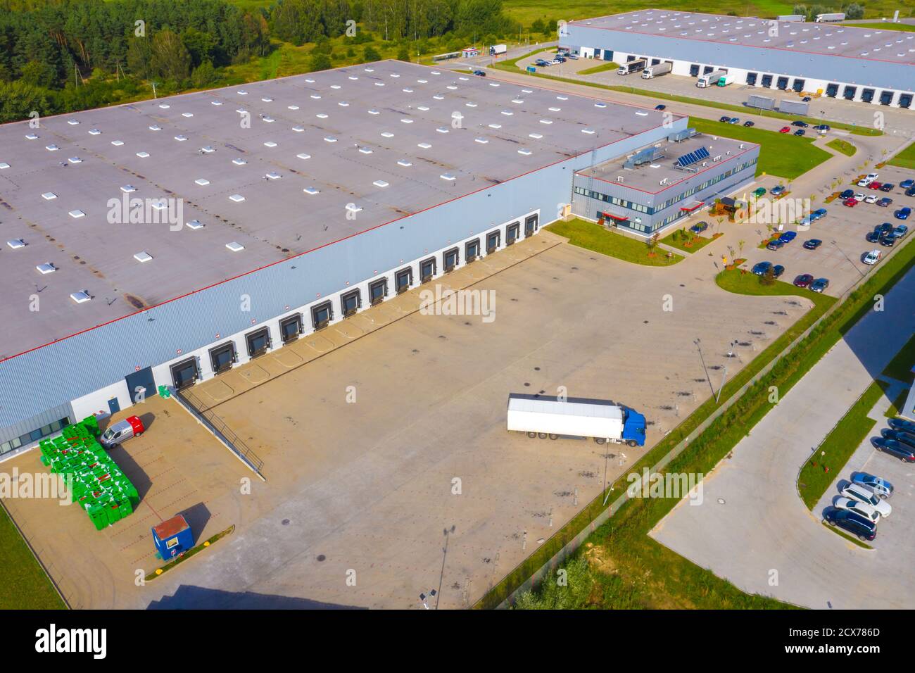 Aerial view of warehouse with trucks. Industrial background. Logistics ...