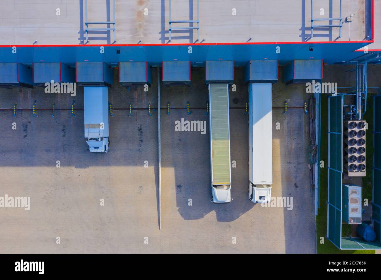 Aerial view of warehouse with trucks. Industrial background. Logistics ...