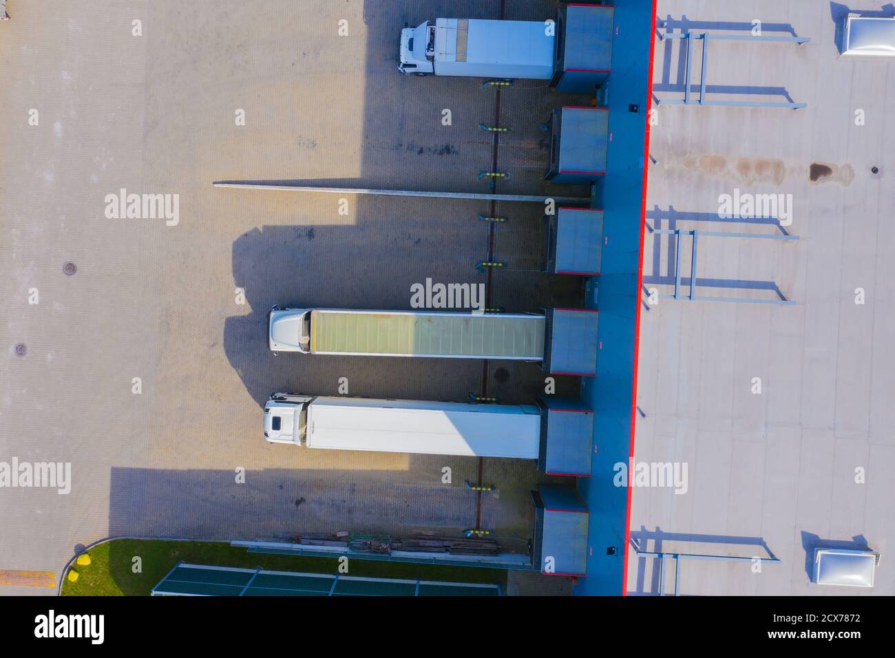 Aerial view of warehouse with trucks. Industrial background. Logistics ...