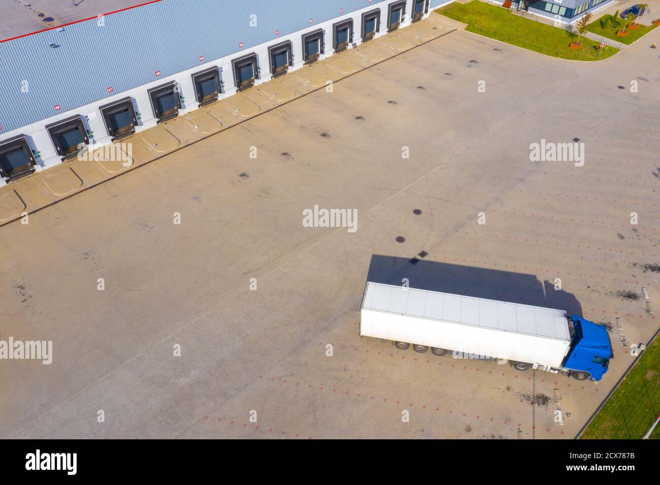 Aerial view of warehouse with trucks. Industrial background. Logistics ...