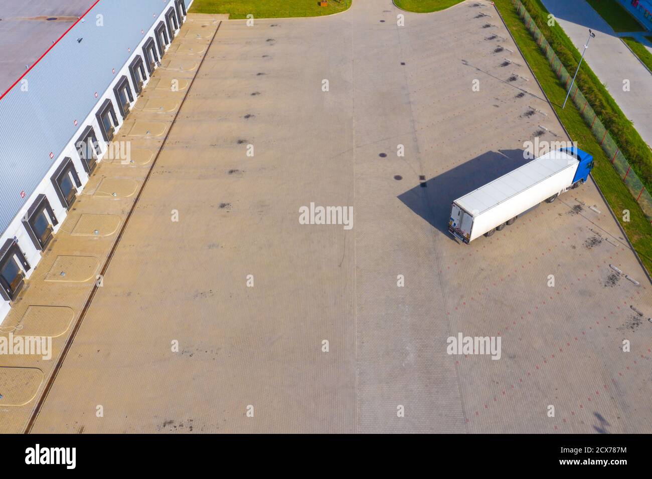 Aerial view of warehouse with trucks. Industrial background. Logistics ...