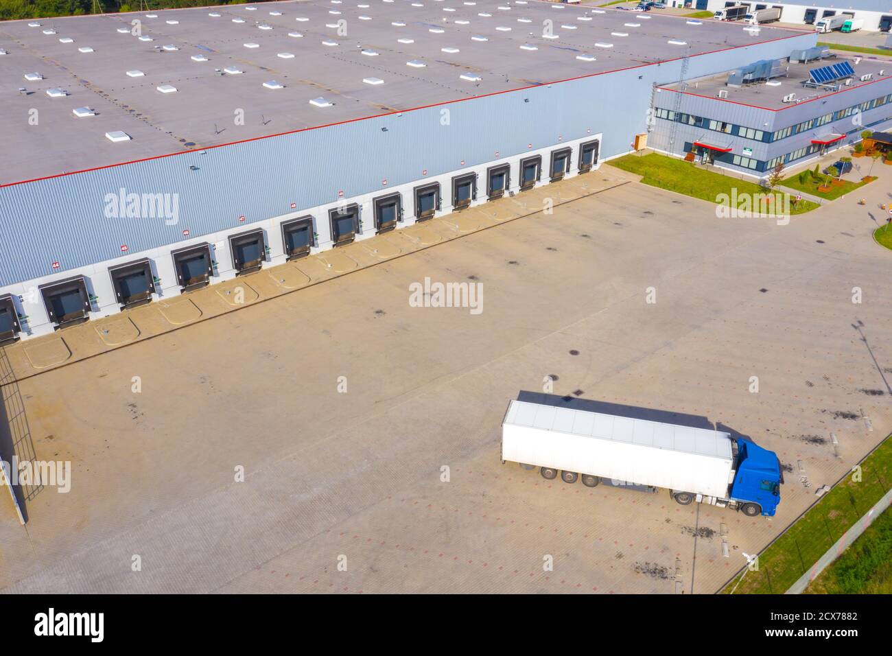 Aerial view of warehouse with trucks. Industrial background. Logistics ...