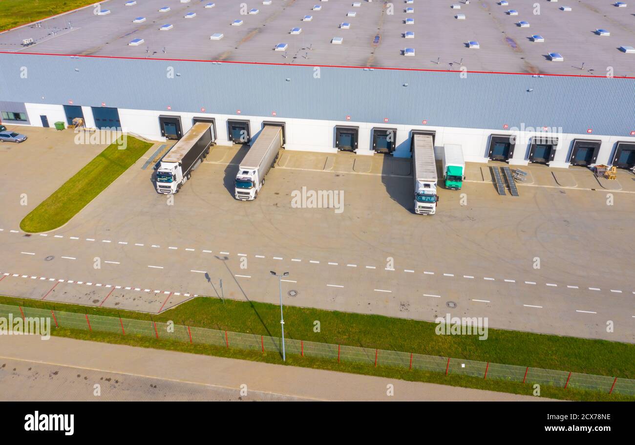 Aerial top view of truck and cargo trailer unloading in logostics ...