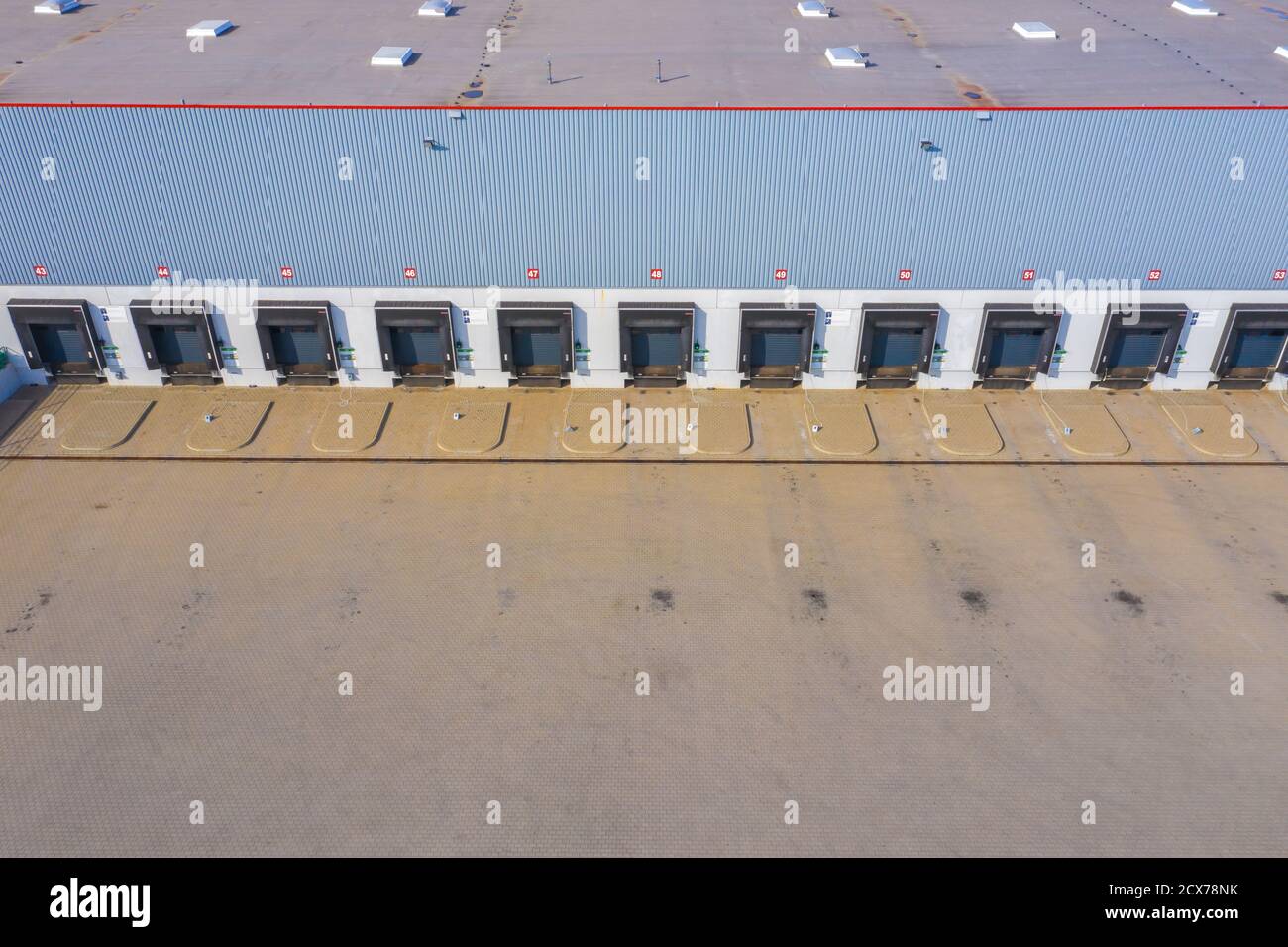 Aerial top view of truck and cargo trailer unloading in logostics ...