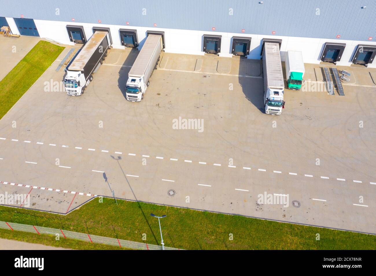 Aerial top view of truck and cargo trailer unloading in logostics ...