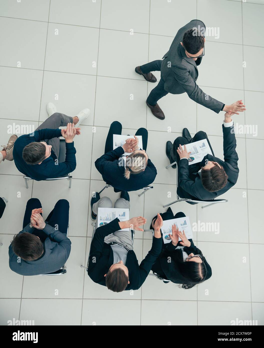 happy employees giving each other a high five at a work meeting Stock ...