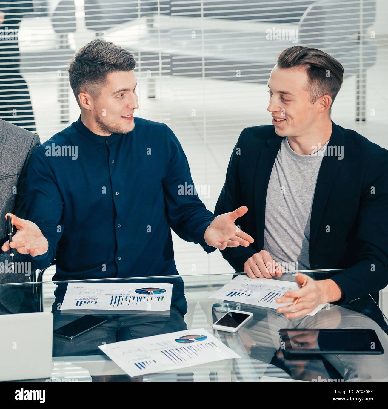group of employees sitting at an office Desk Stock Photo - Alamy