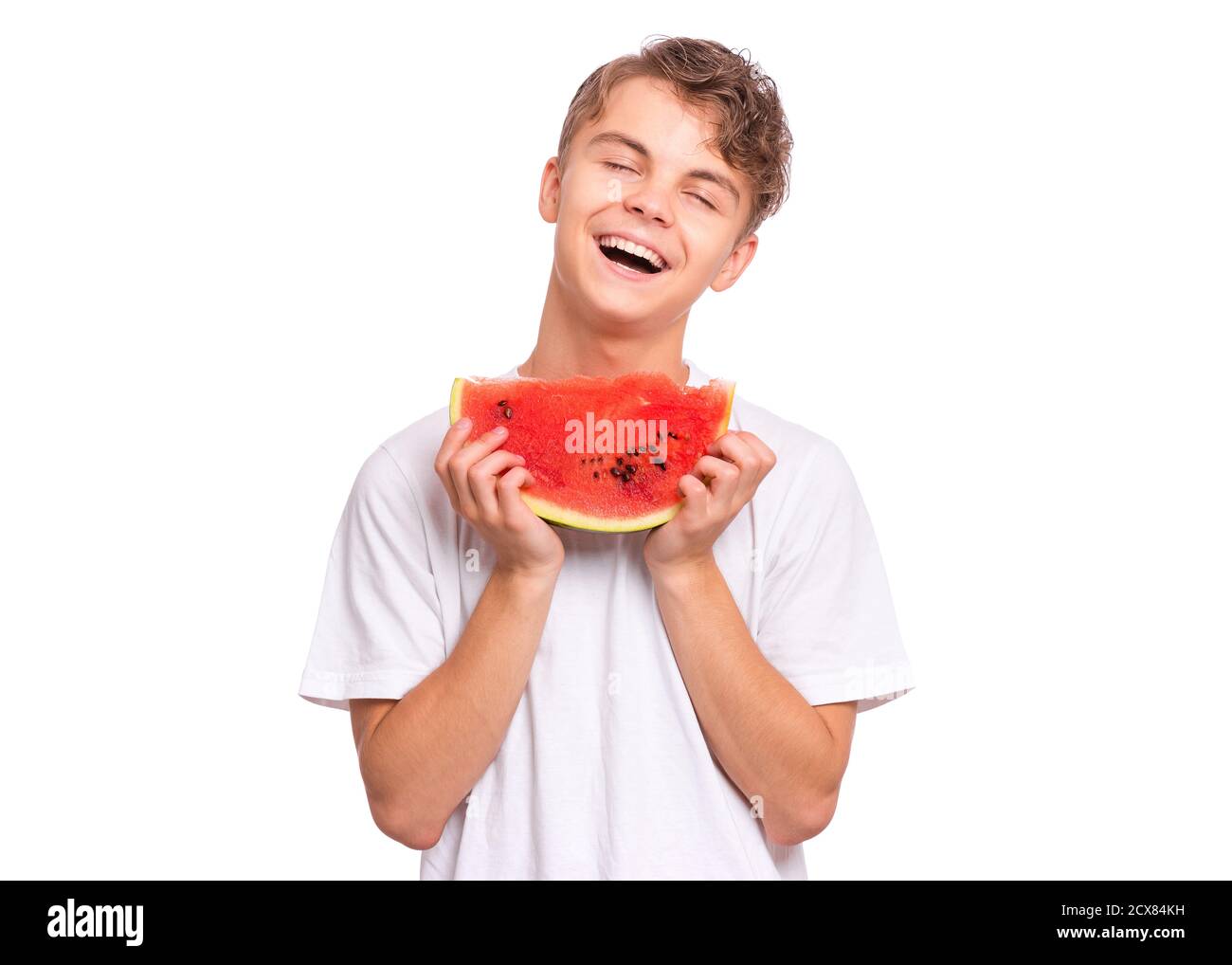 Teen boy eating ripe juicy watermelon and smiling. Cute teenager with ...