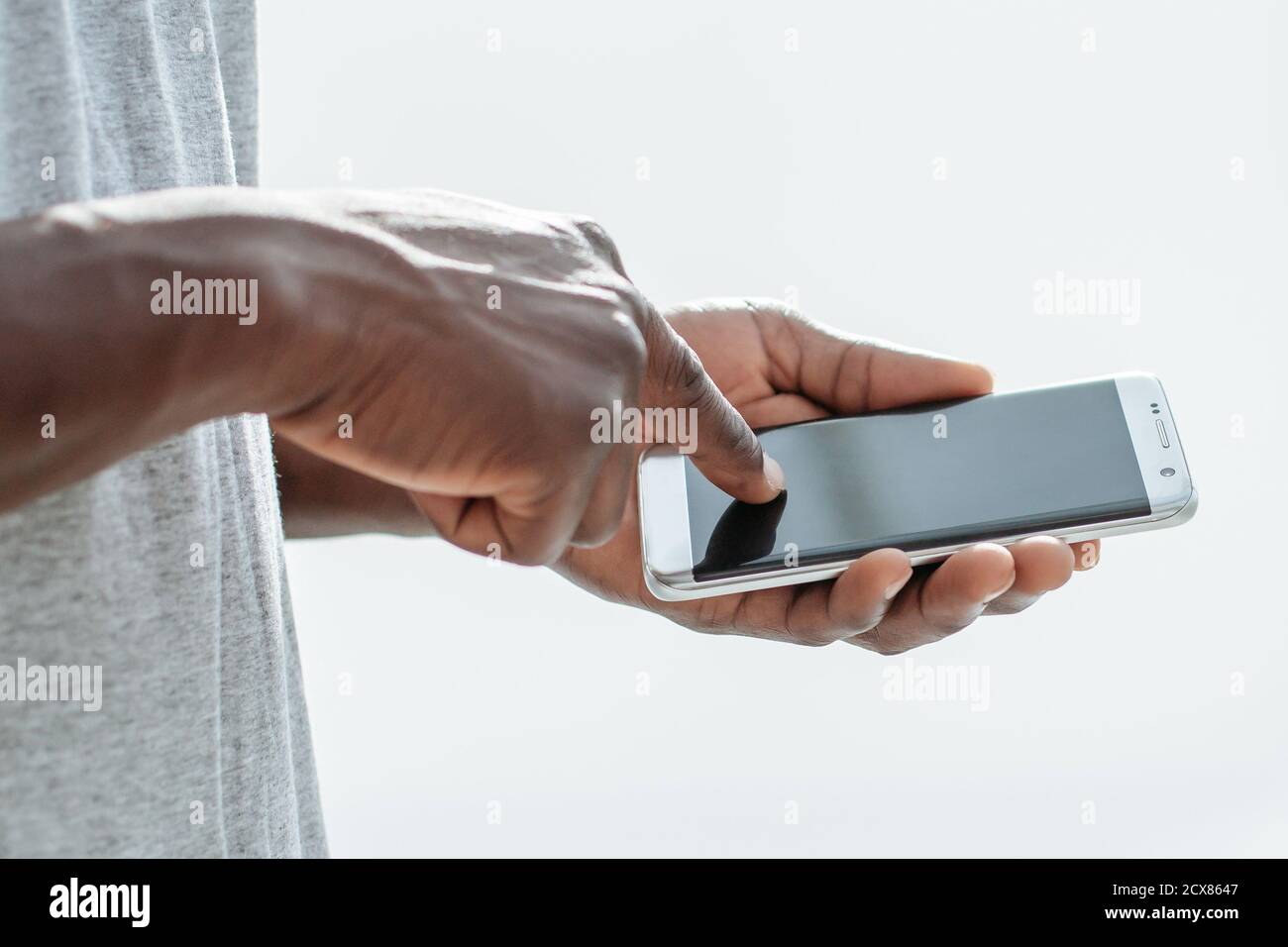 close up.young man tapping the screen of his phone Stock Photo - Alamy