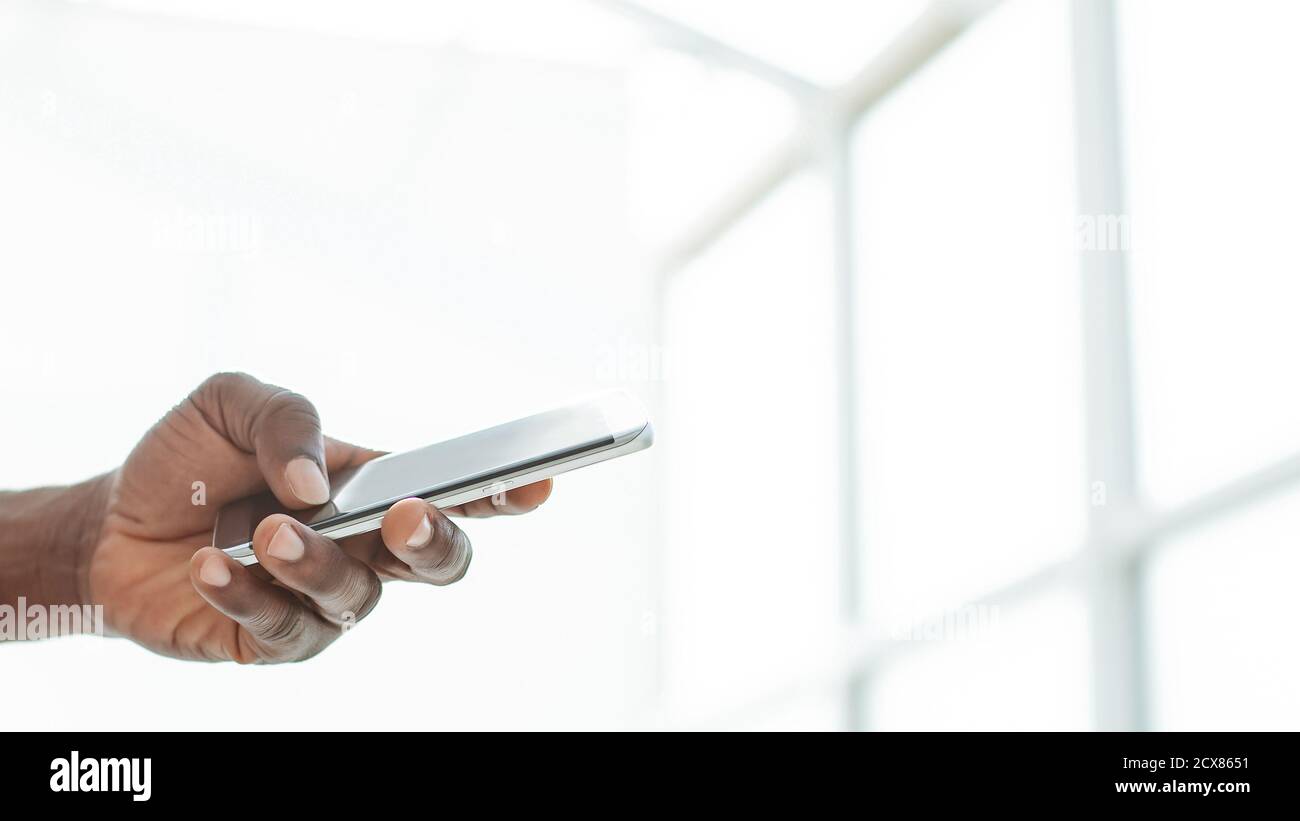 close up. young man looking at the screen of his smartphone Stock Photo ...