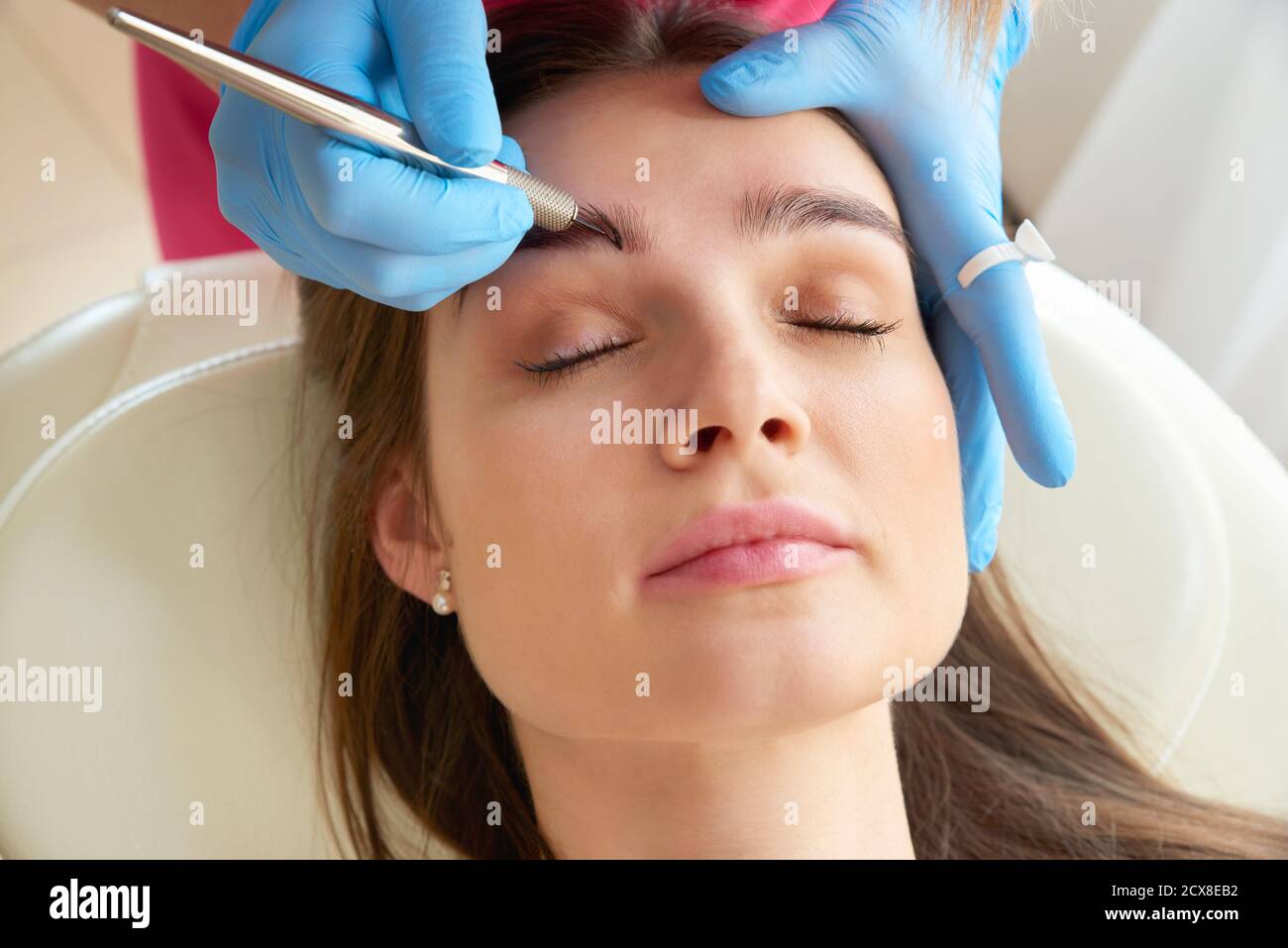 Professional eyebrow correction in beauty salon Stock Photo - Alamy