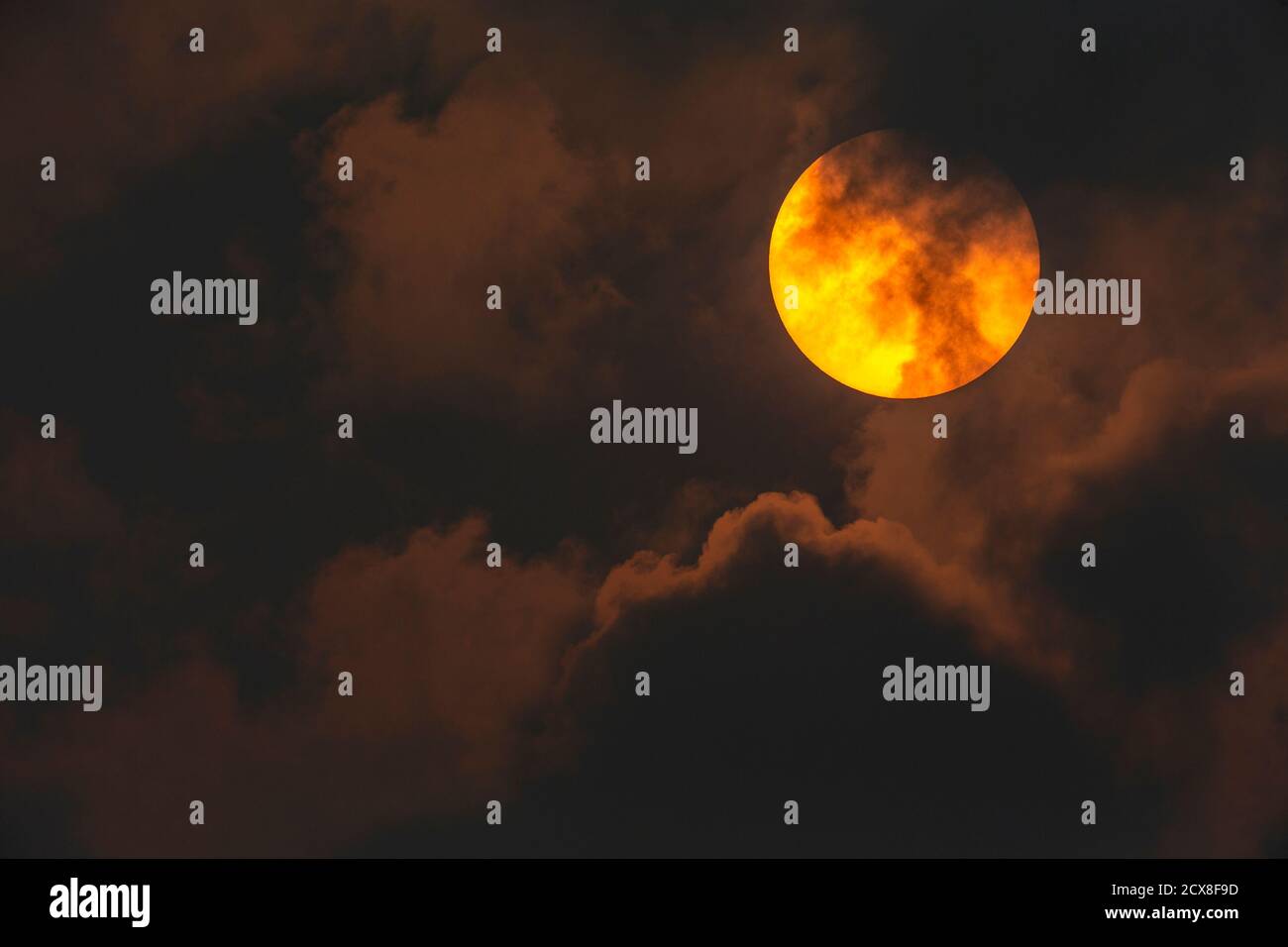 Beautiful golden sun on the cloudy sky Stock Photo - Alamy