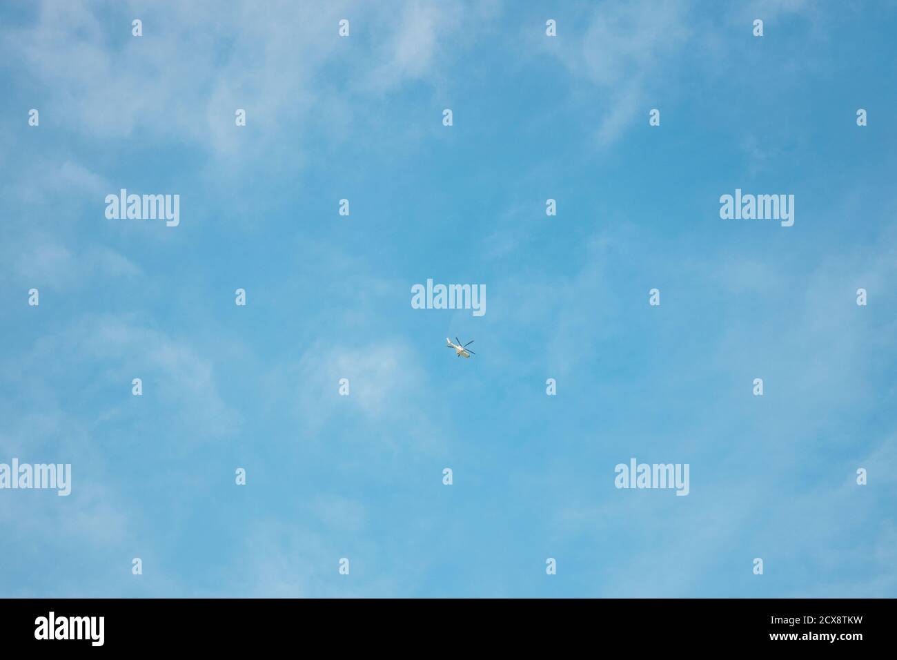 Helicopter high in the sky as seen from the distance Stock Photo - Alamy