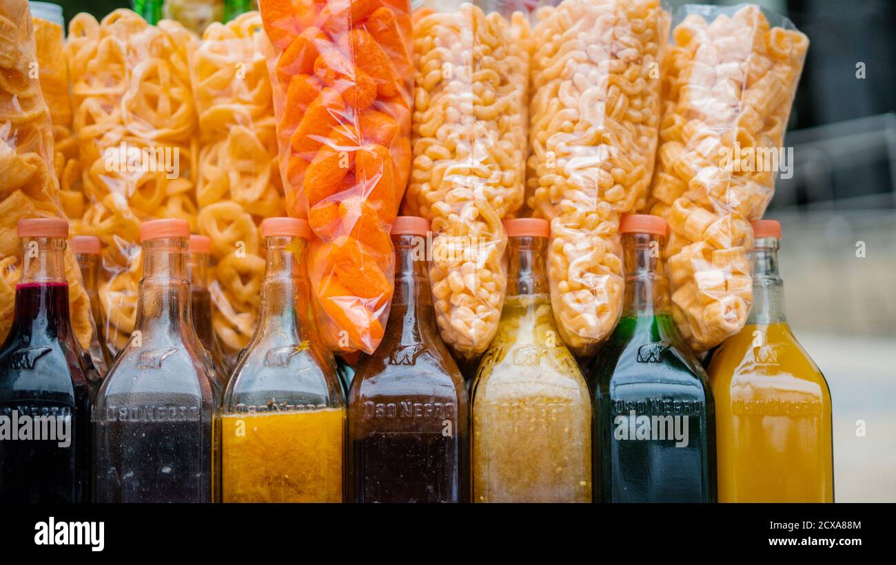 Mexican Fried Snacks and Colorful Slush Syrup Bottles Stock Photo - Alamy