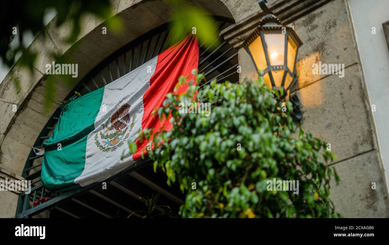 Mexican Flag Hanging Over a Building Arched Entrance Stock Photo - Alamy