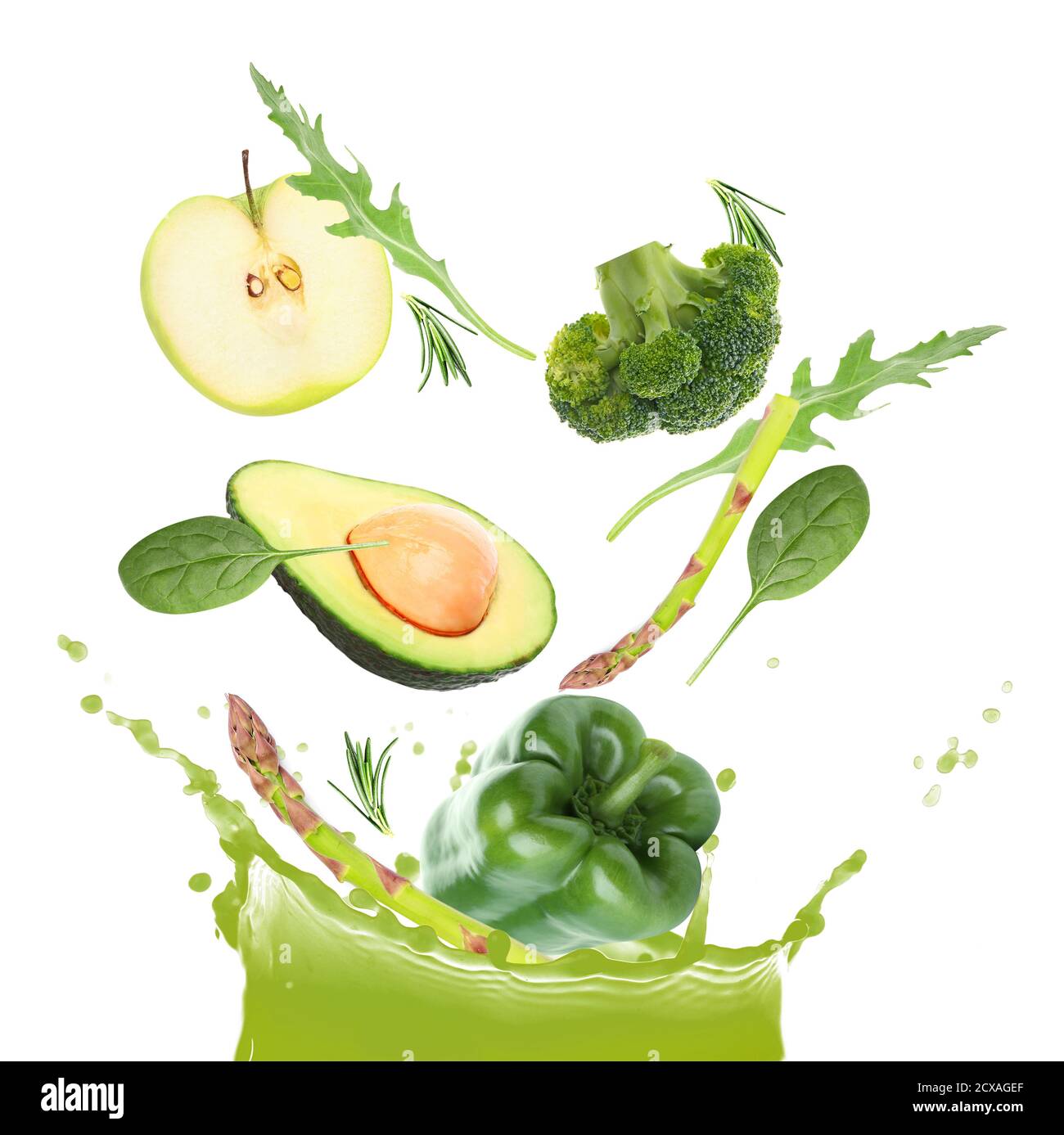 Splash of fresh vegetable juice and flying ingredients on white ...