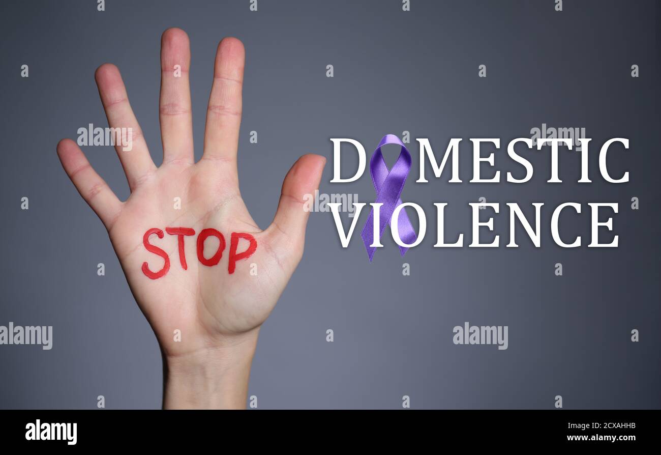 Female hand with text STOP DOMESTIC VIOLENCE on grey background Stock ...