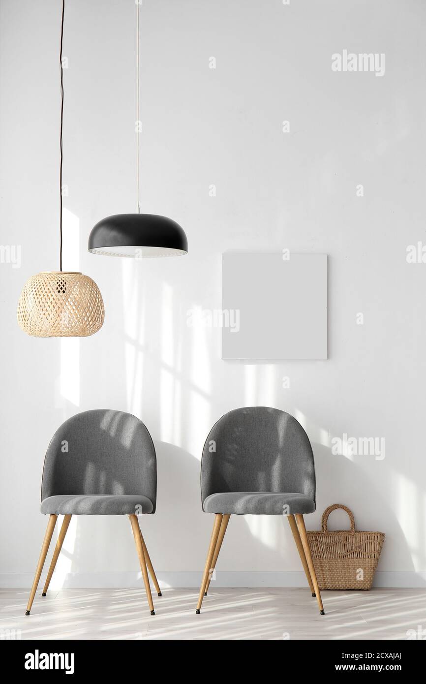 Blank poster with chairs in minimal interior of room Stock Photo - Alamy