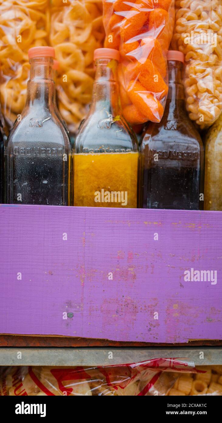 Mexican Fried Snacks and Slush Syrup Bottles On a Purple Wooden Stand ...