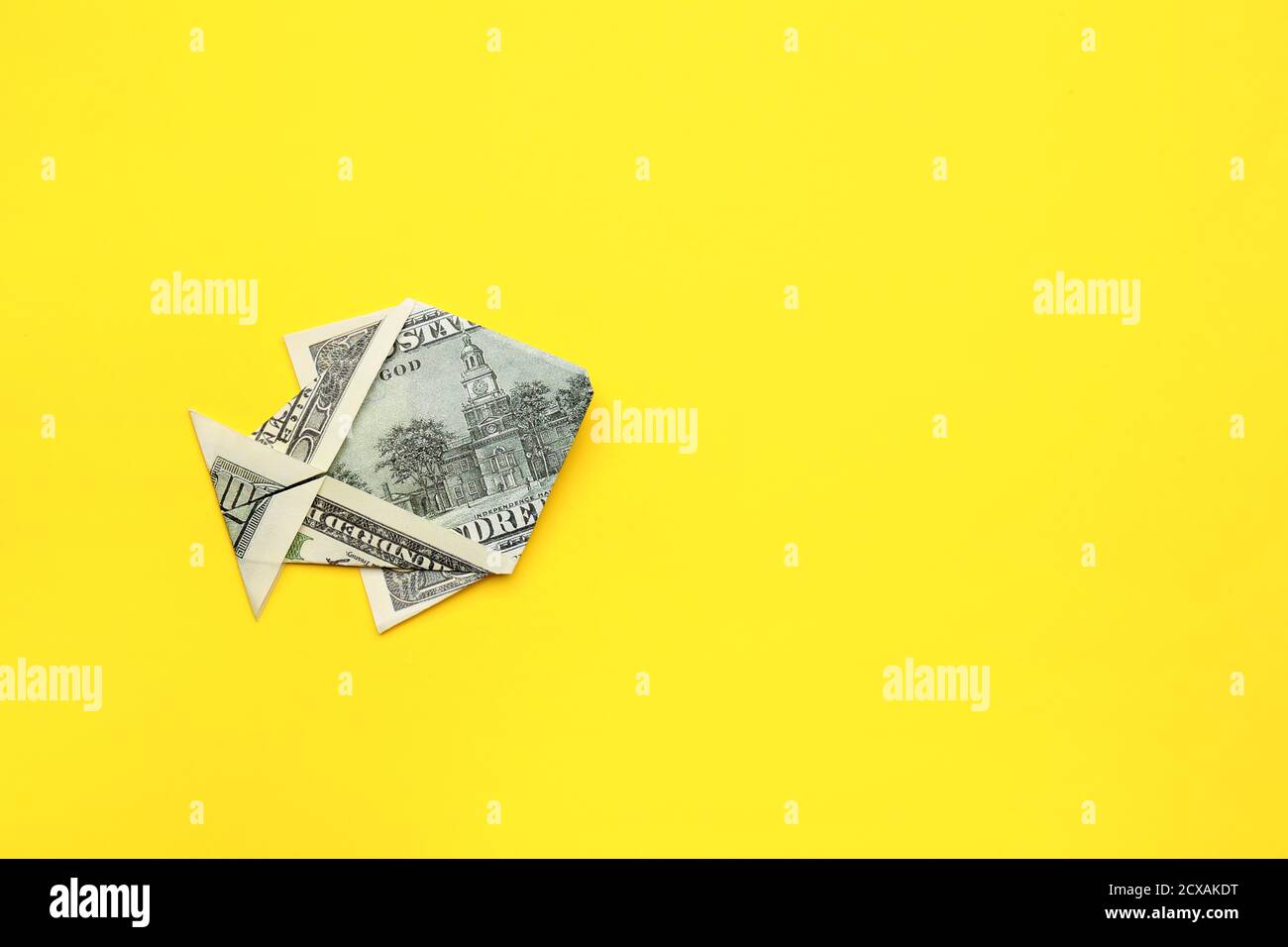 Origami fish made of dollar banknote on color background Stock Photo ...