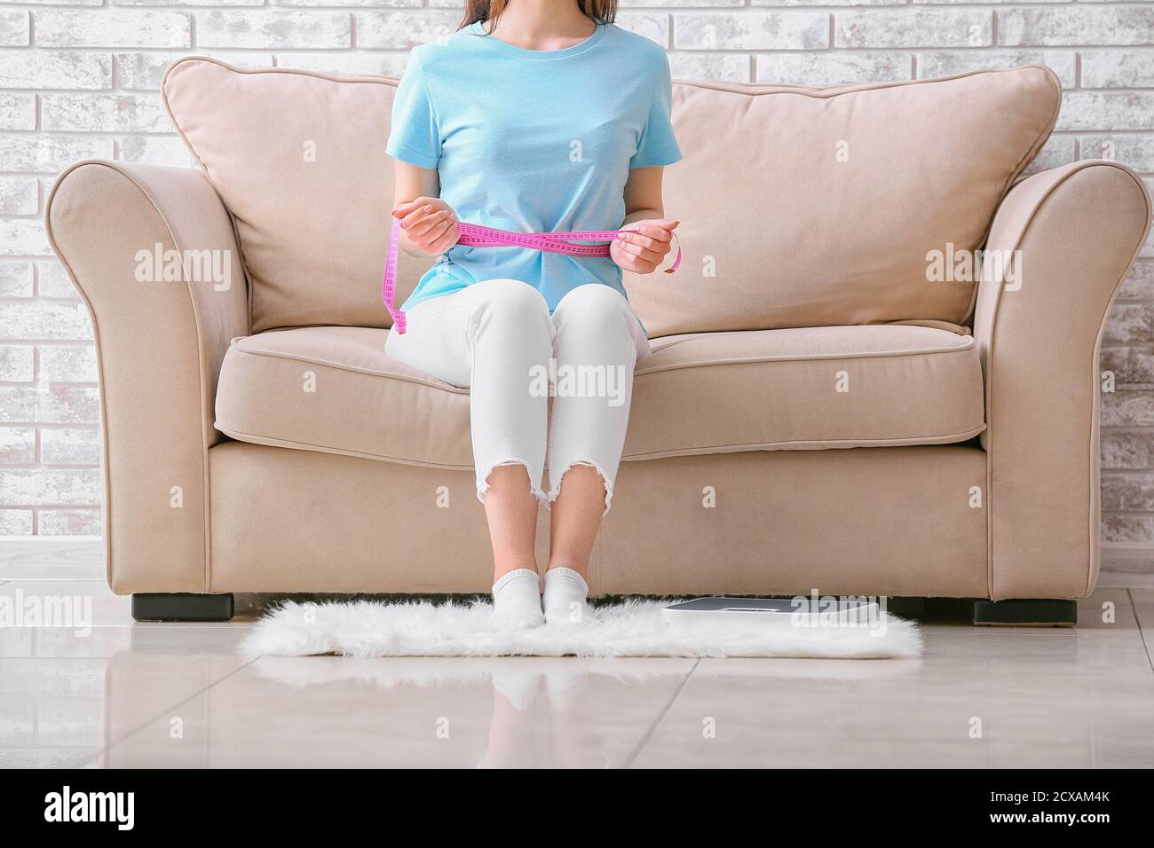 Skinny woman measuring her waist at home. Concept of anorexia Stock ...