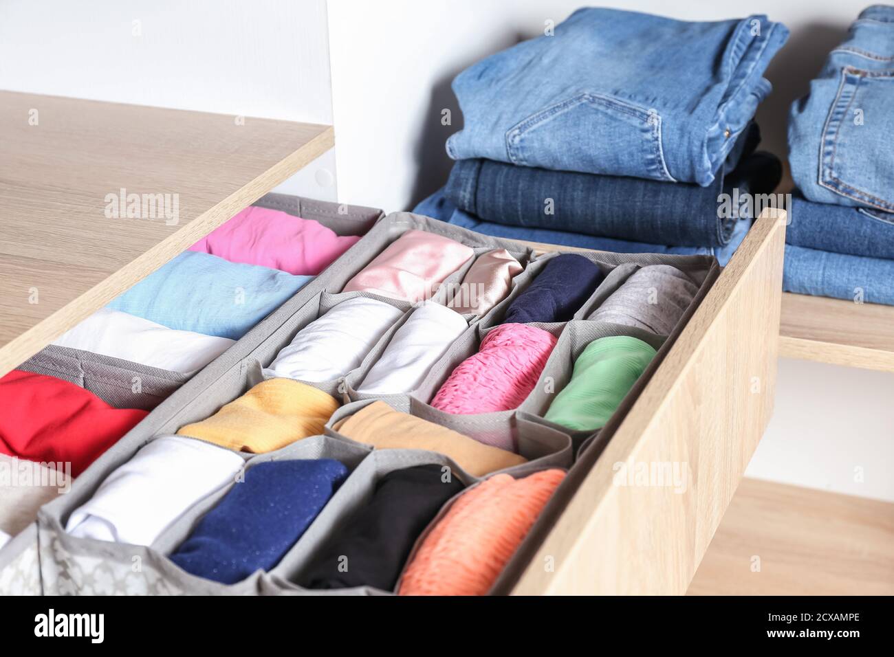 Open drawer with clean clothes in closet Stock Photo - Alamy