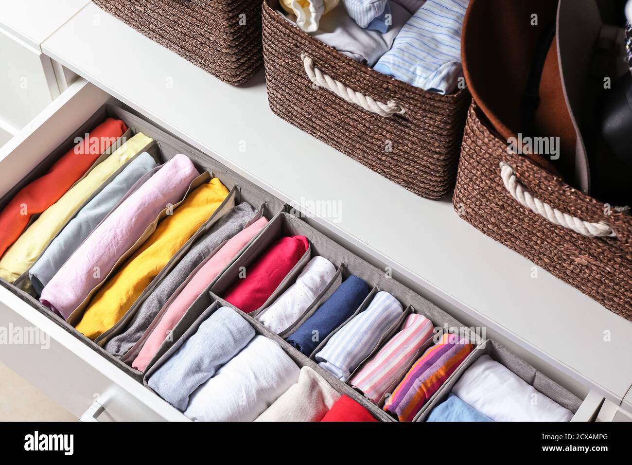 Open drawer with clean clothes in closet Stock Photo - Alamy