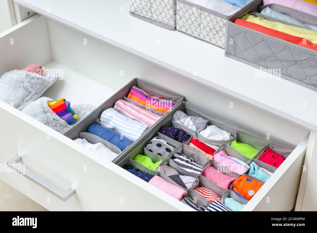Open drawer with clean clothes in closet Stock Photo - Alamy