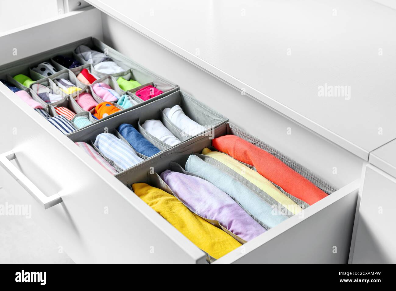 Open drawer with clean clothes in closet Stock Photo - Alamy