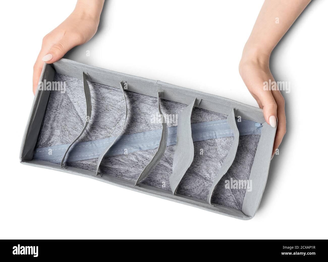 Female hands with empty organizer for clean clothes on white background ...