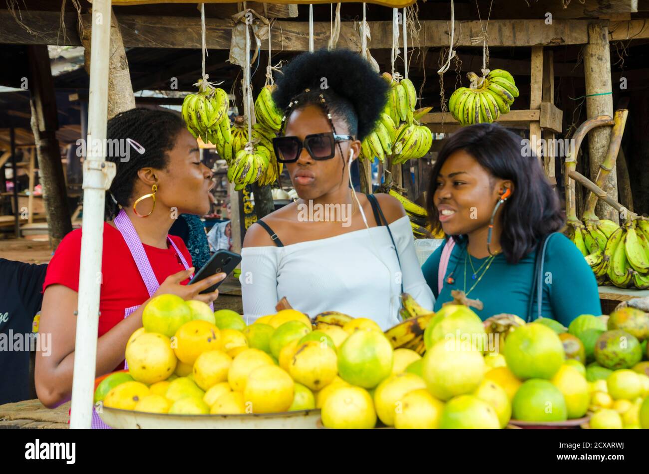 a beautiful african market woman and her customers feeling excited as ...