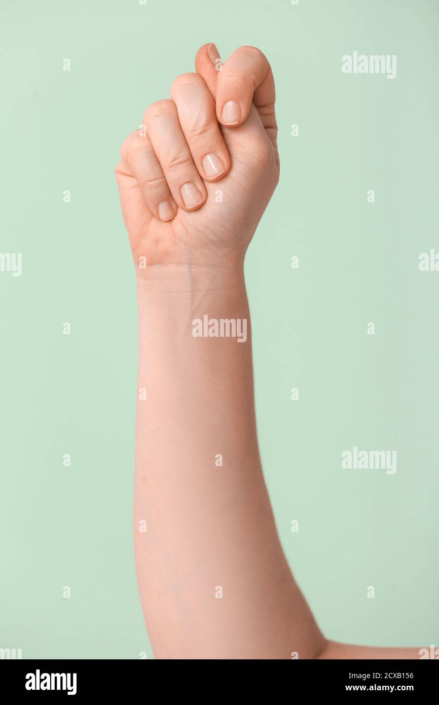 Hand showing letter T on color background. Sign language alphabet Stock ...