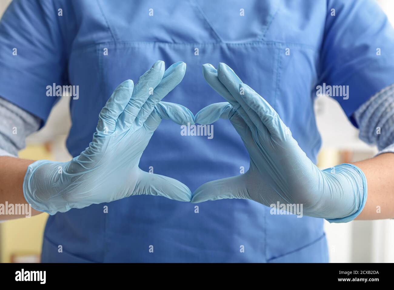 Doctor showing heart shape with hands in clinic Stock Photo - Alamy