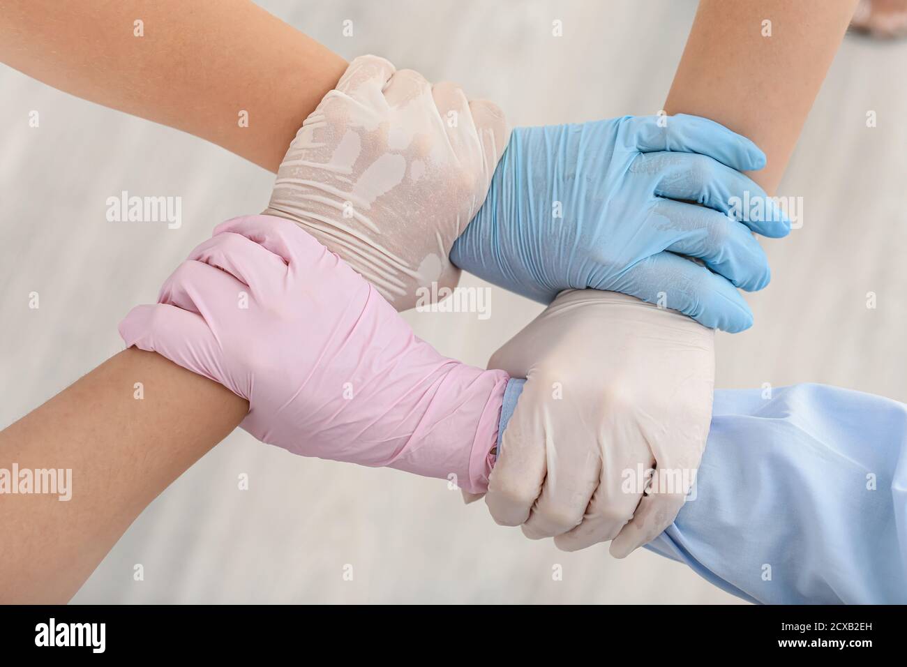 Team work different hands gloves hi-res stock photography and images ...