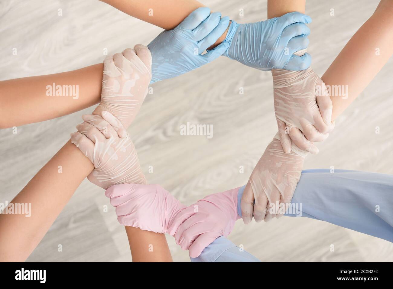 Team work different hands gloves hi-res stock photography and images ...