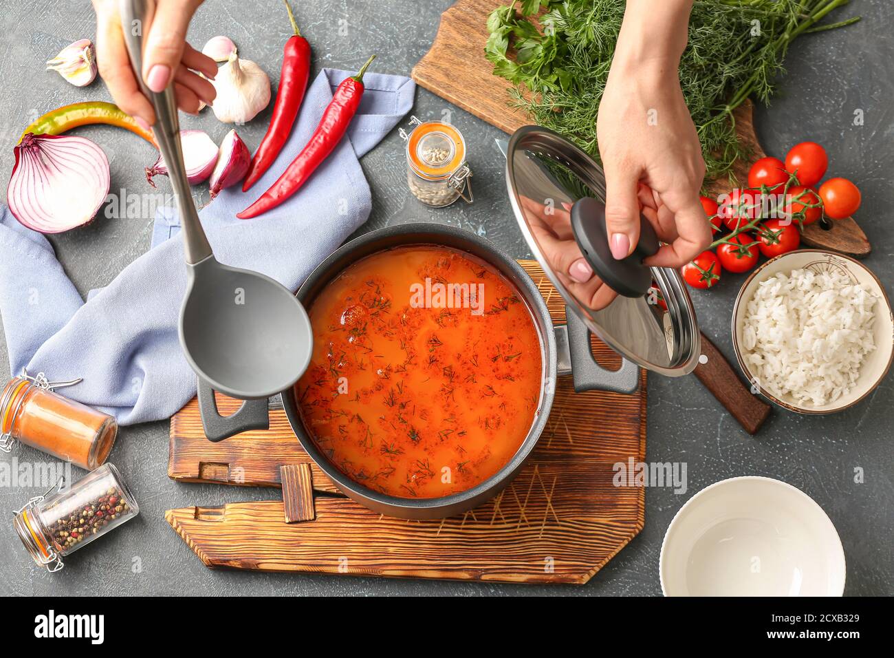 Woman pouring tasty rice soup from pot Stock Photo - Alamy