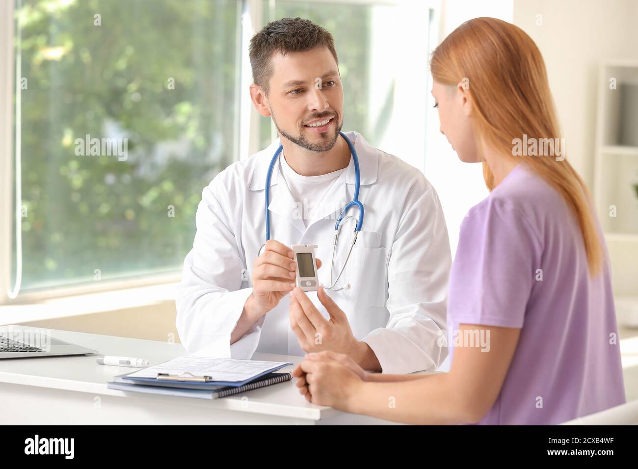 Diabetic woman visiting doctor in clinic Stock Photo - Alamy