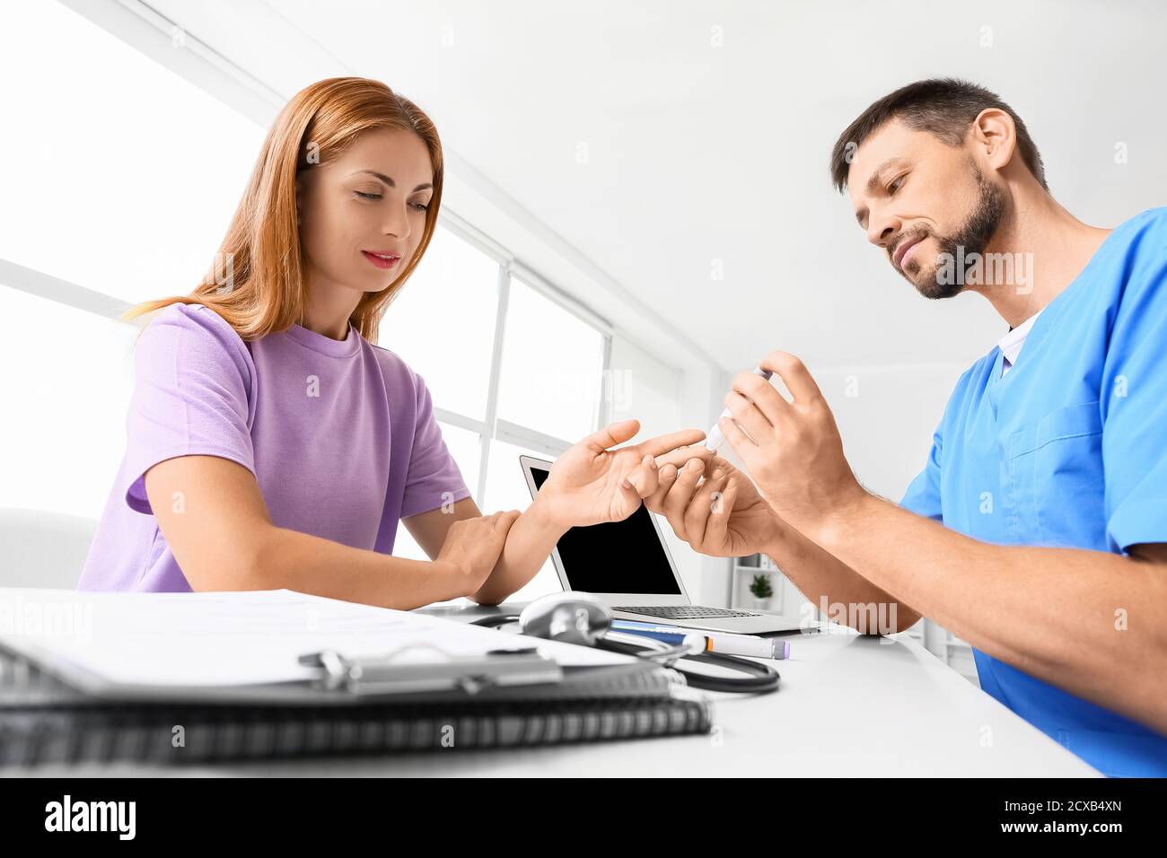 Diabetic woman visiting doctor in clinic Stock Photo - Alamy
