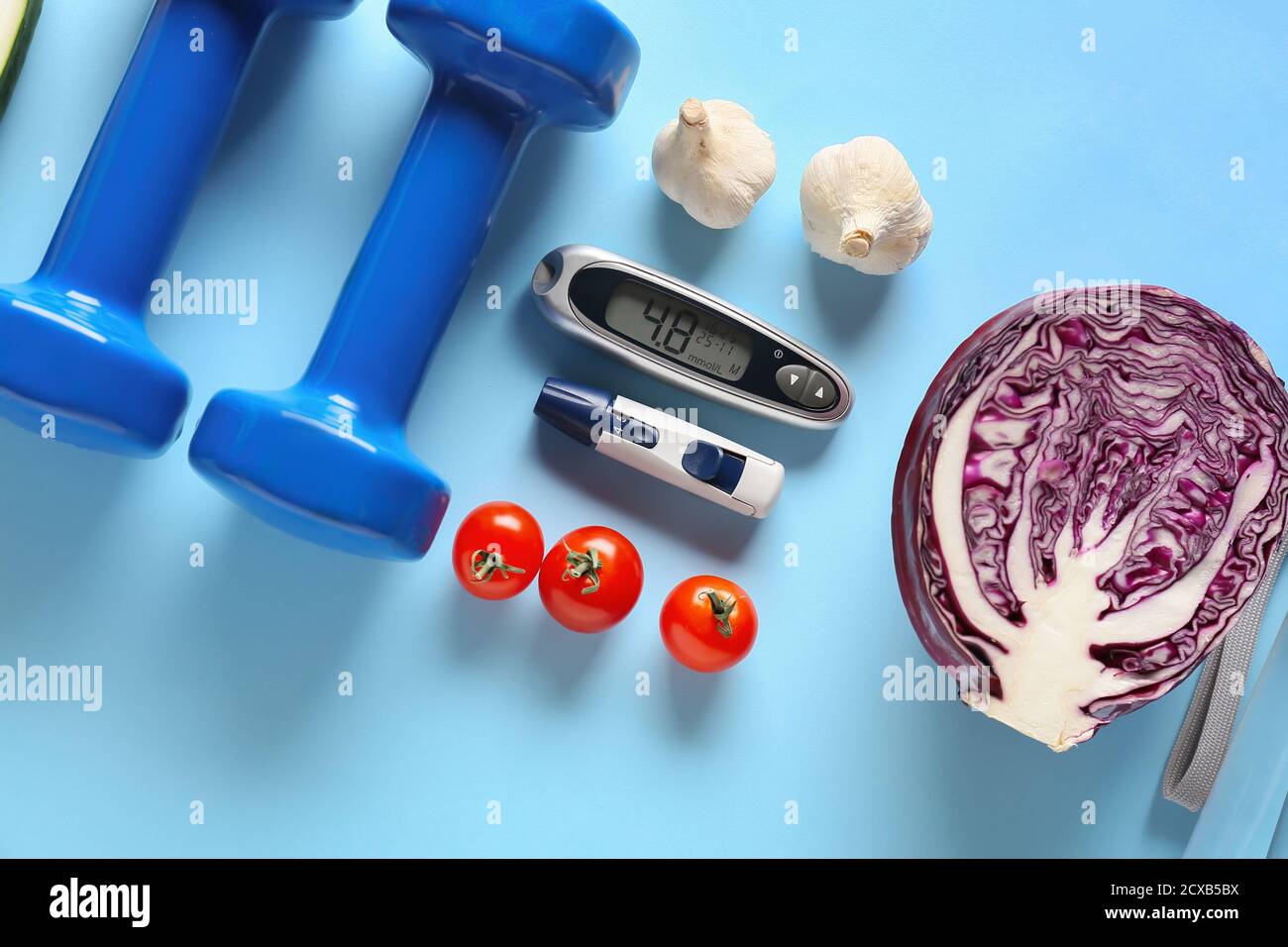 Vegetables, dumbbells, lancet pen and glucometer on color background ...