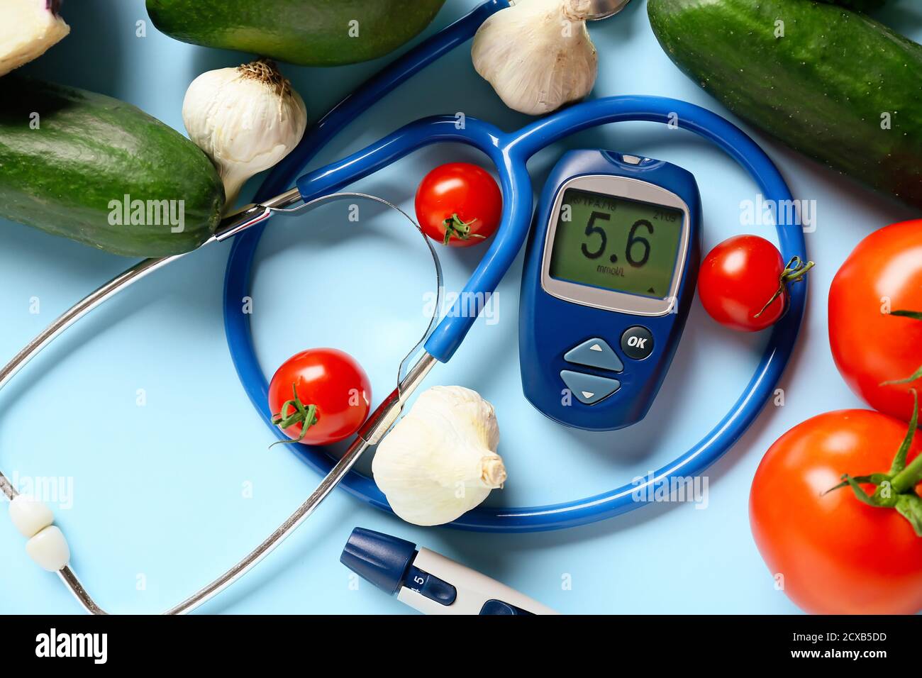 Vegetables, stethoscope, lancet pen and glucometer on color background ...