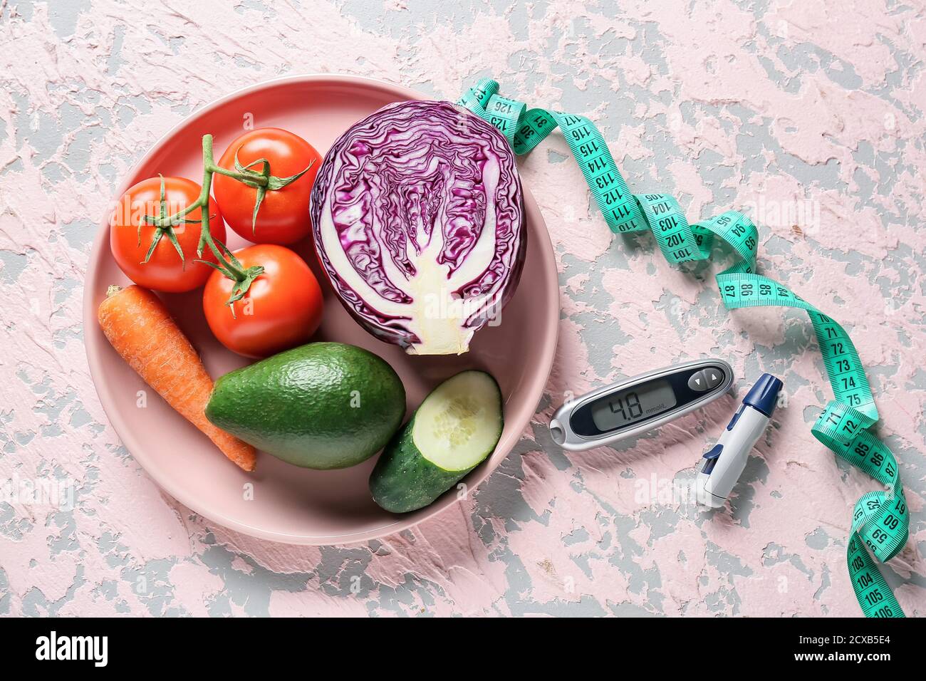 Vegetables, measuring tape, lancet pen and glucometer on color ...