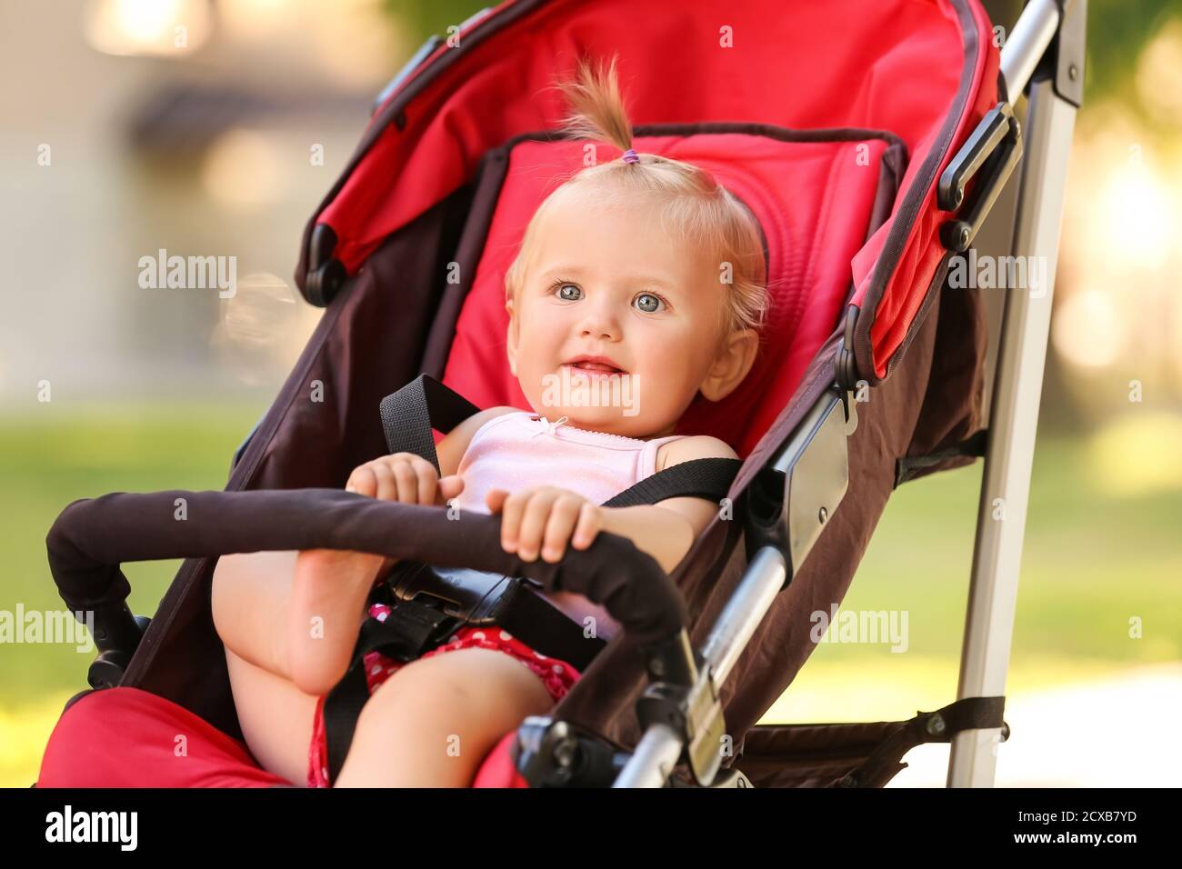 Cute baby in stroller outdoors Stock Photo - Alamy