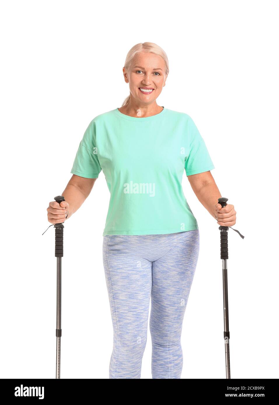 Mature woman with walking poles on white background Stock Photo - Alamy