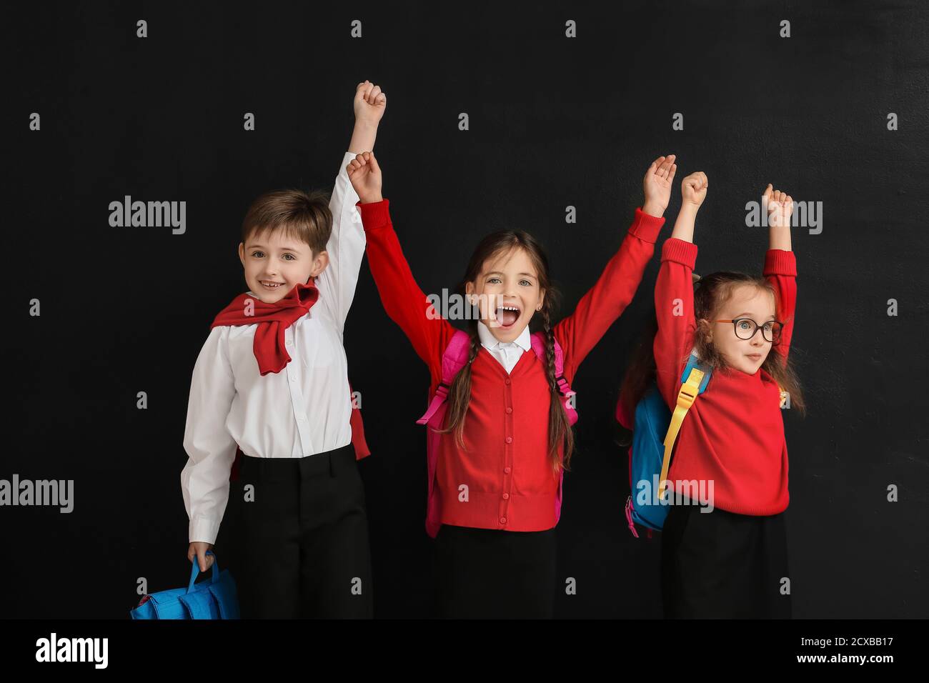Happy little pupils on dark background Stock Photo - Alamy